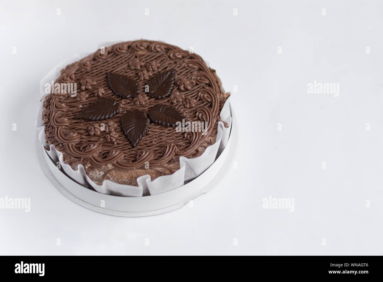 Chocolate round cake top view on white background table. Sweet dessert ...