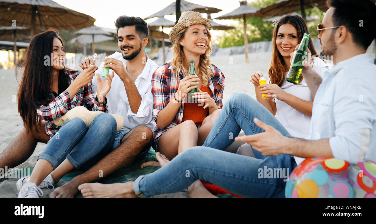 Group of happy friends partying on beach Stock Photo - Alamy