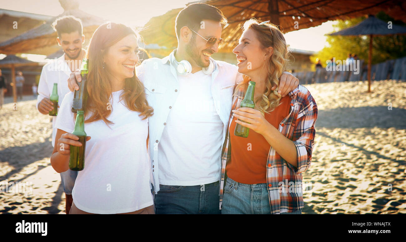 Group of happy friends partying on beach Stock Photo - Alamy
