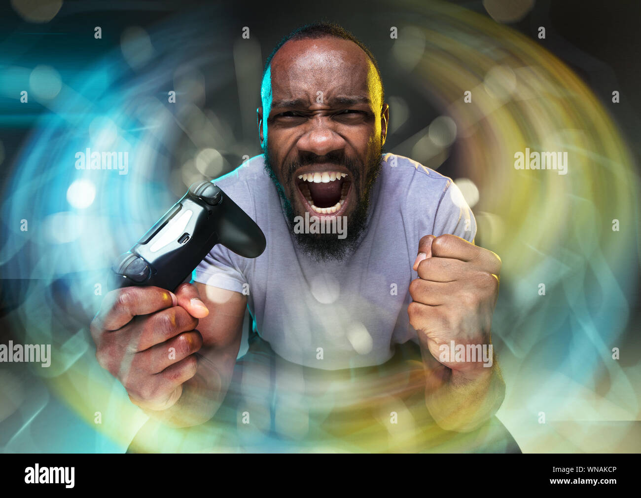 Full immersion in gameplay. Young man holding a video game controller ...