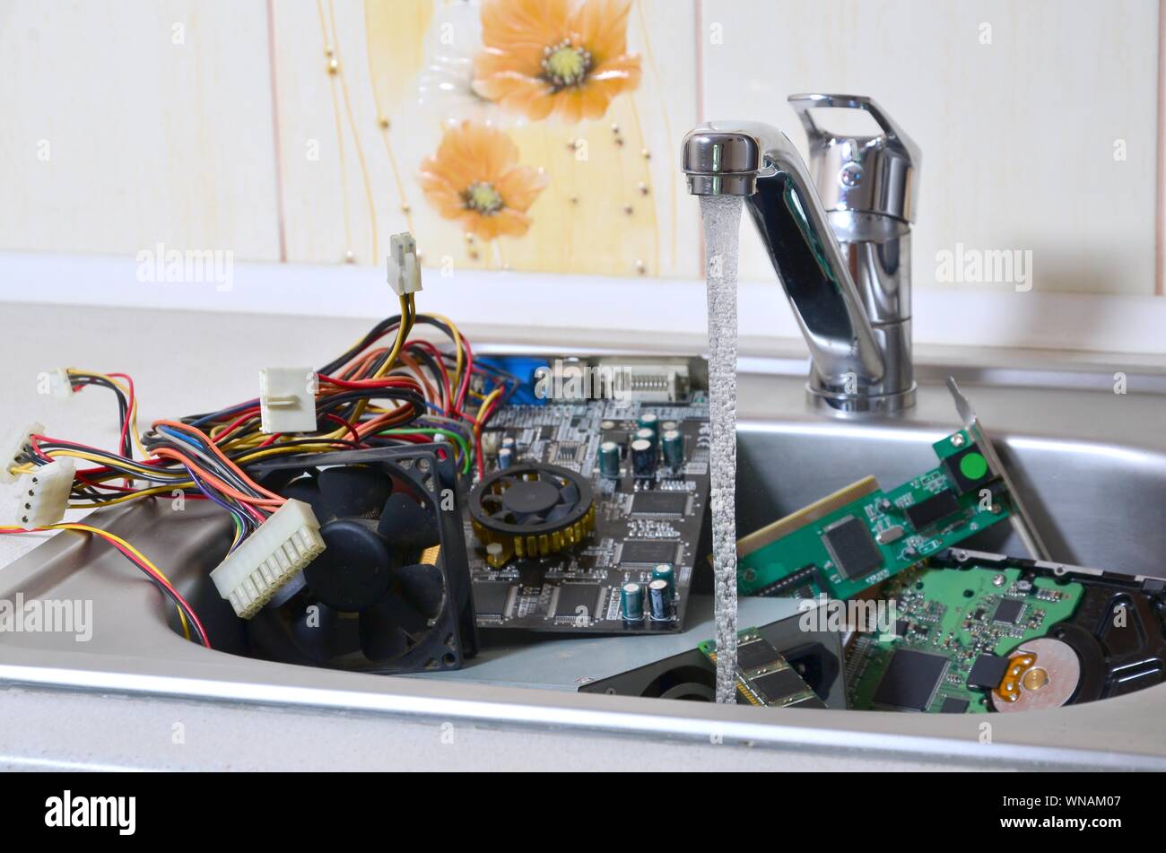 Personal computer cleaning metaphoric concept. Hardware in kitchen sink ...