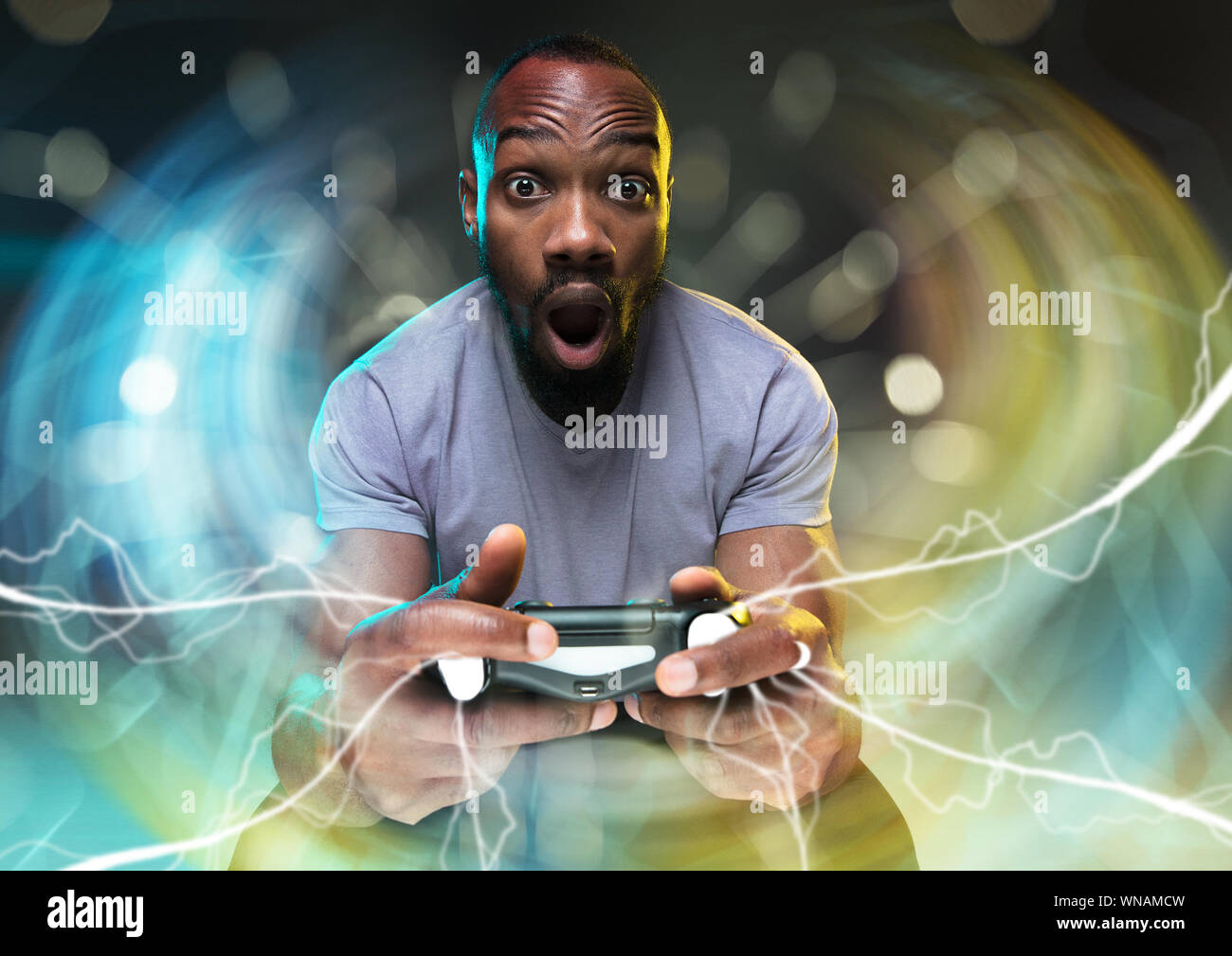 Full immersion in gameplay. Young man holding a video game controller ...