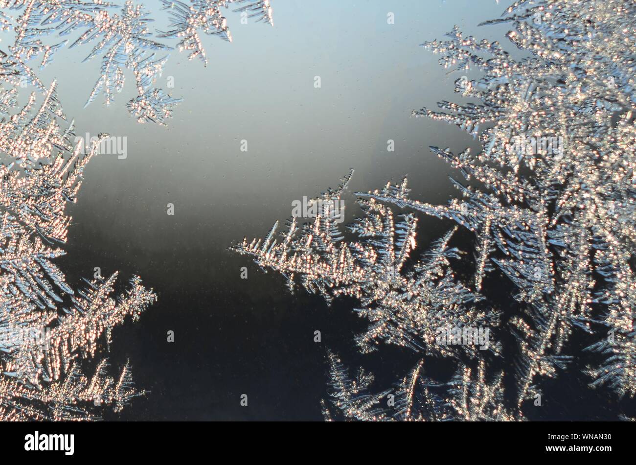 Snowflakes frost rime macro on window glass pane. Colorful ice on the ...