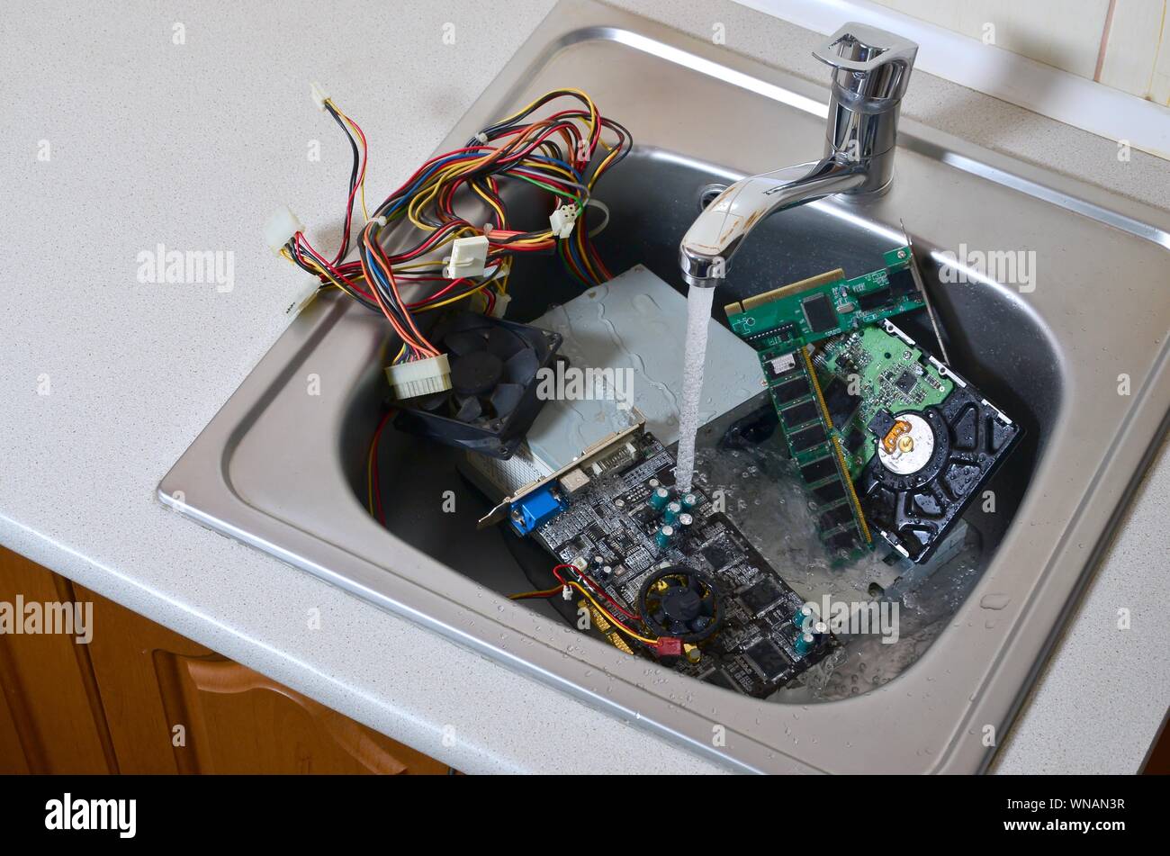 Personal computer cleaning metaphoric concept. Hardware in kitchen sink ...