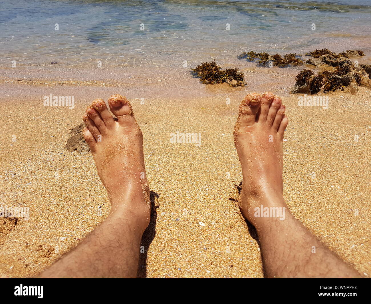 Man relaxing beach barefoot hi-res stock photography and images - Alamy