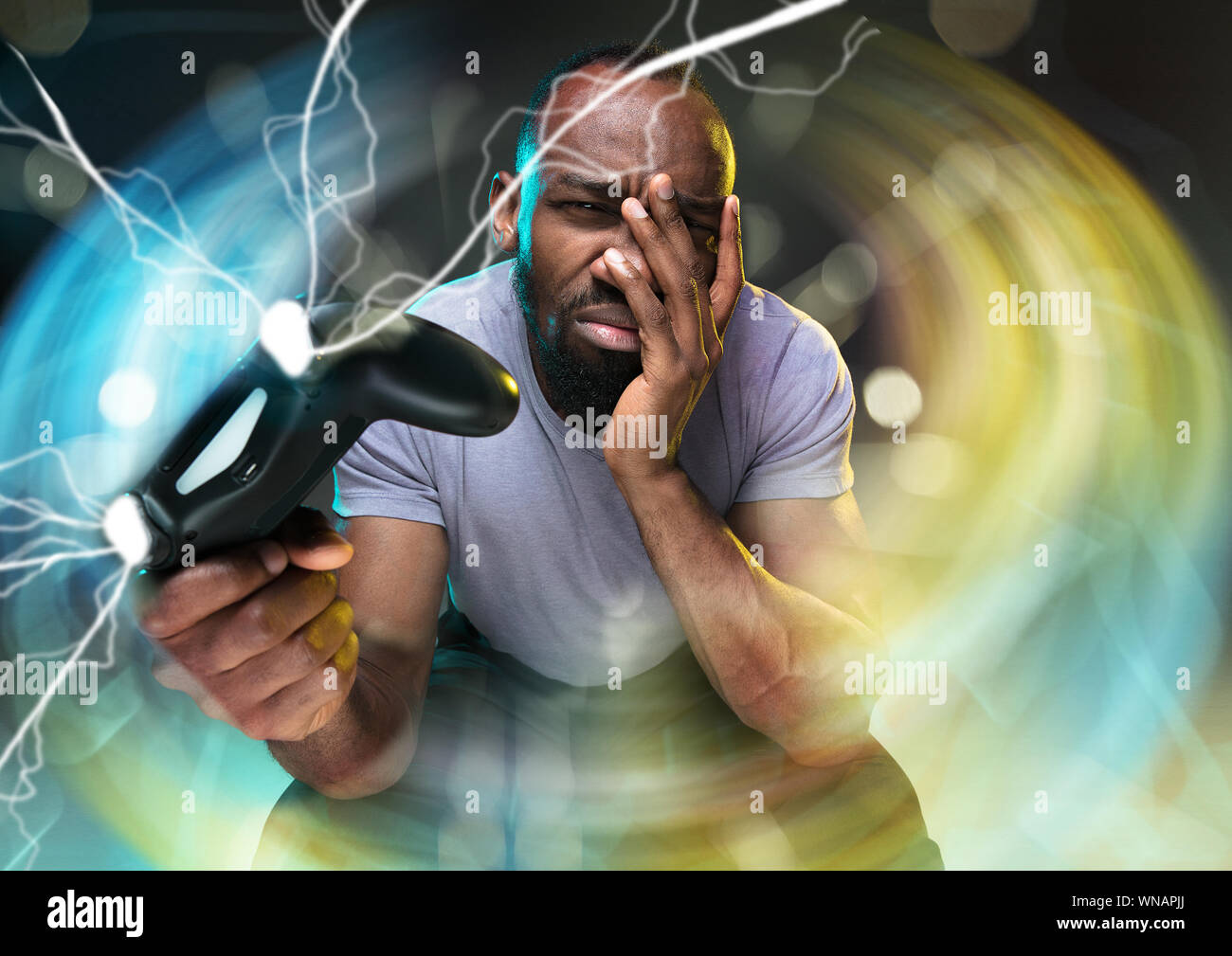 Full immersion in gameplay. Young man holding a video game controller ...