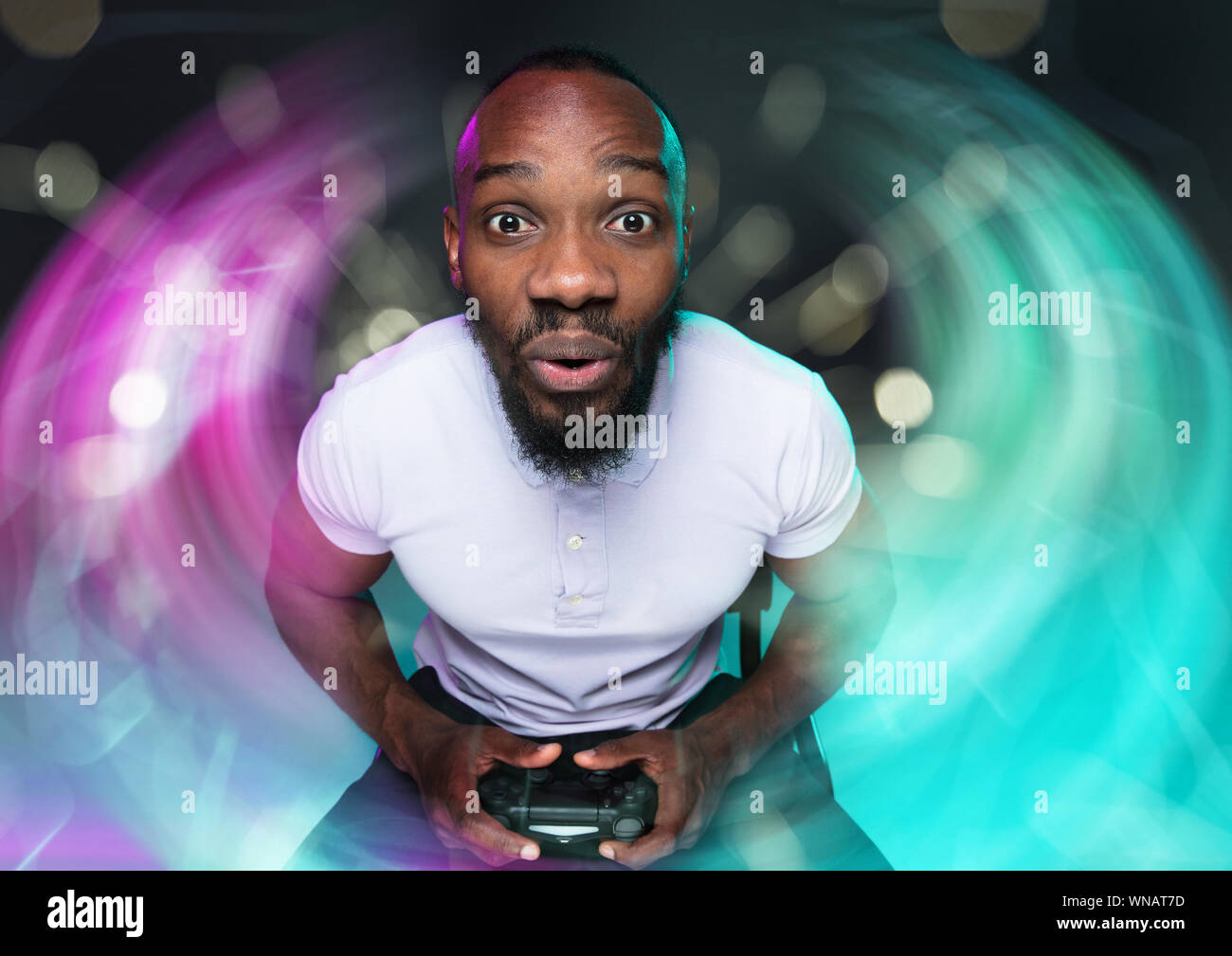 Passioned for winning. Young man holding a video game controller ...