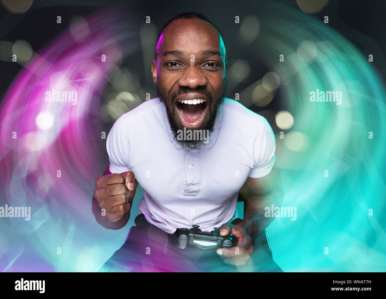 Passioned for winning. Young man holding a video game controller ...