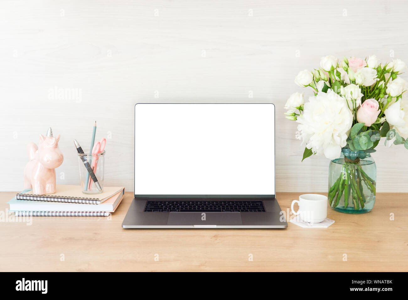 Feminine office desk table with laptop computer with blank white screen ...