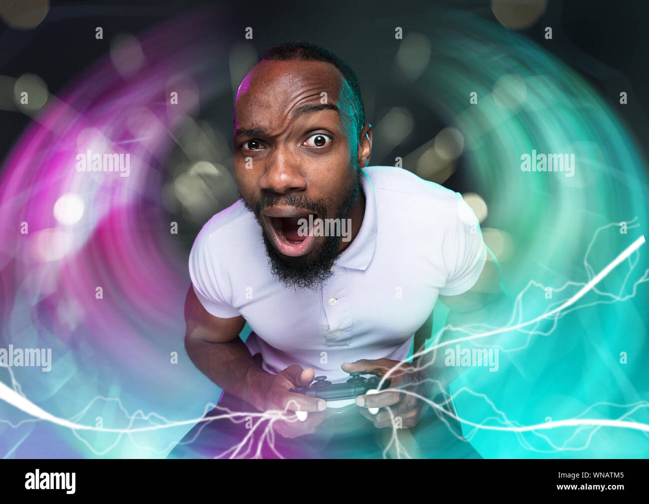 Passioned for winning. Young man holding a video game controller ...
