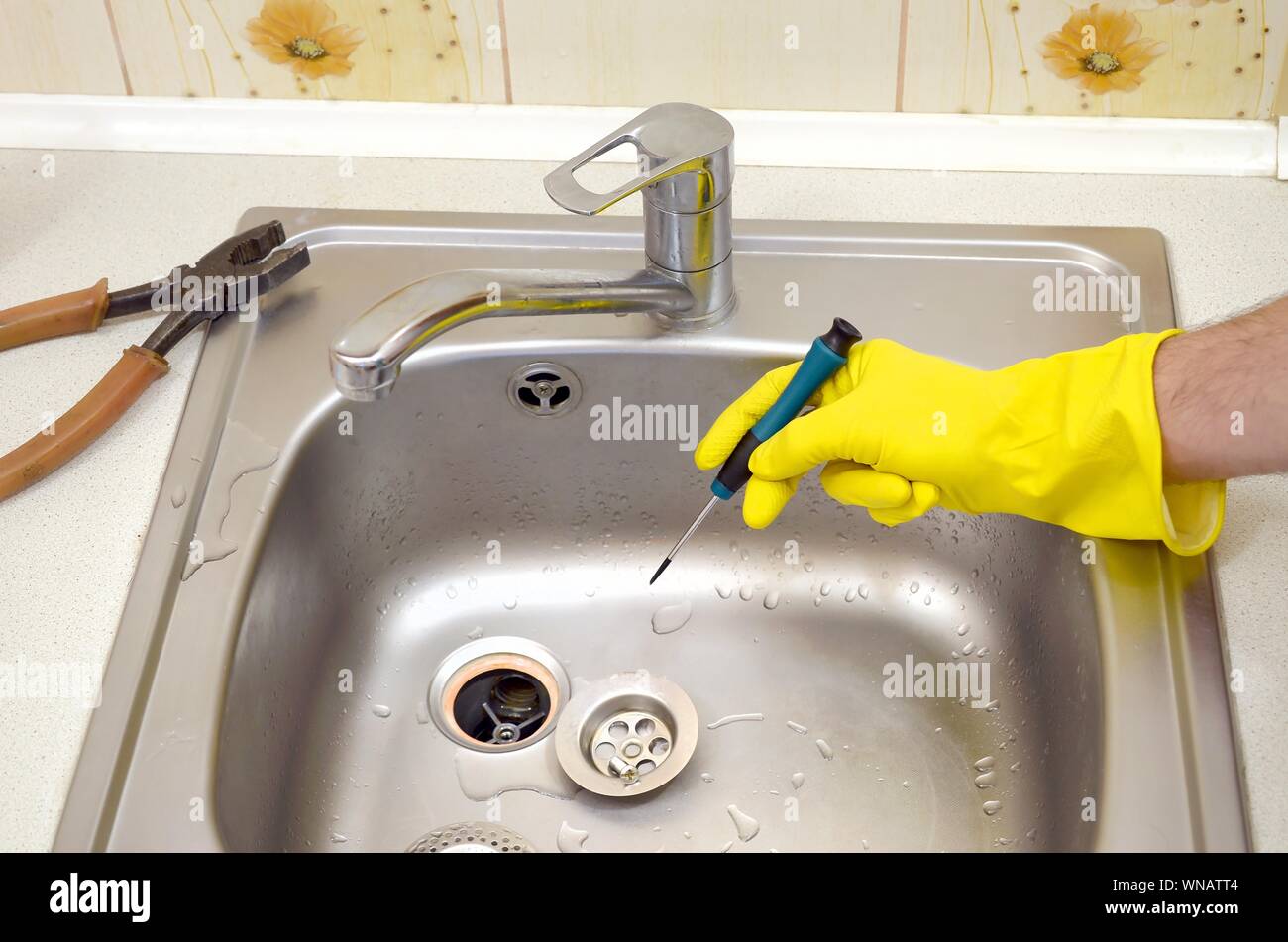 Handsome plumber repairing drain sink hi-res stock photography and ...