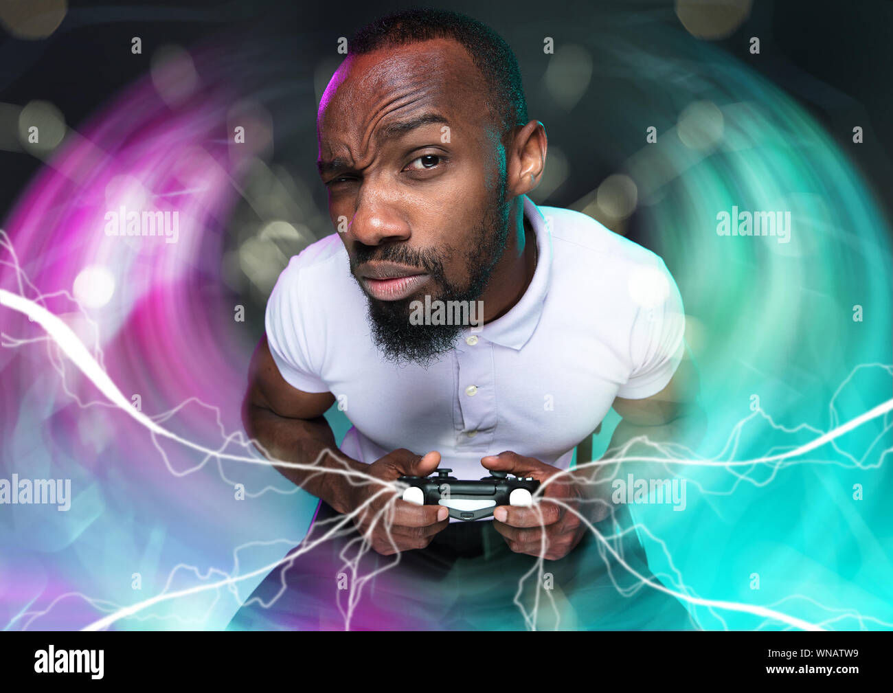 Passioned for winning. Young man holding a video game controller ...