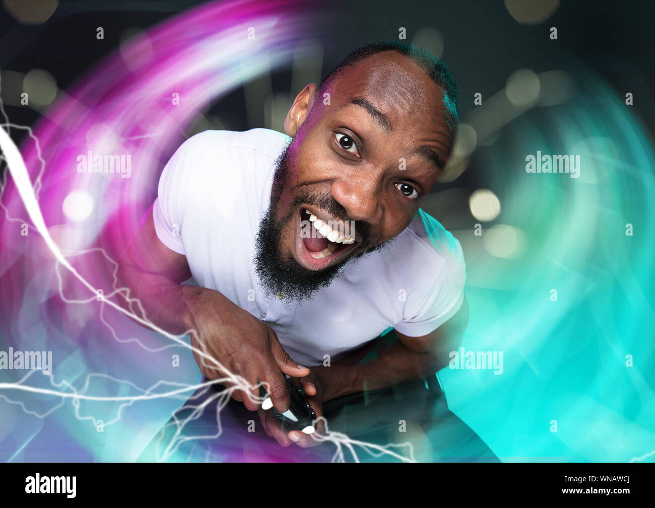 Passioned for winning. Young man holding a video game controller ...