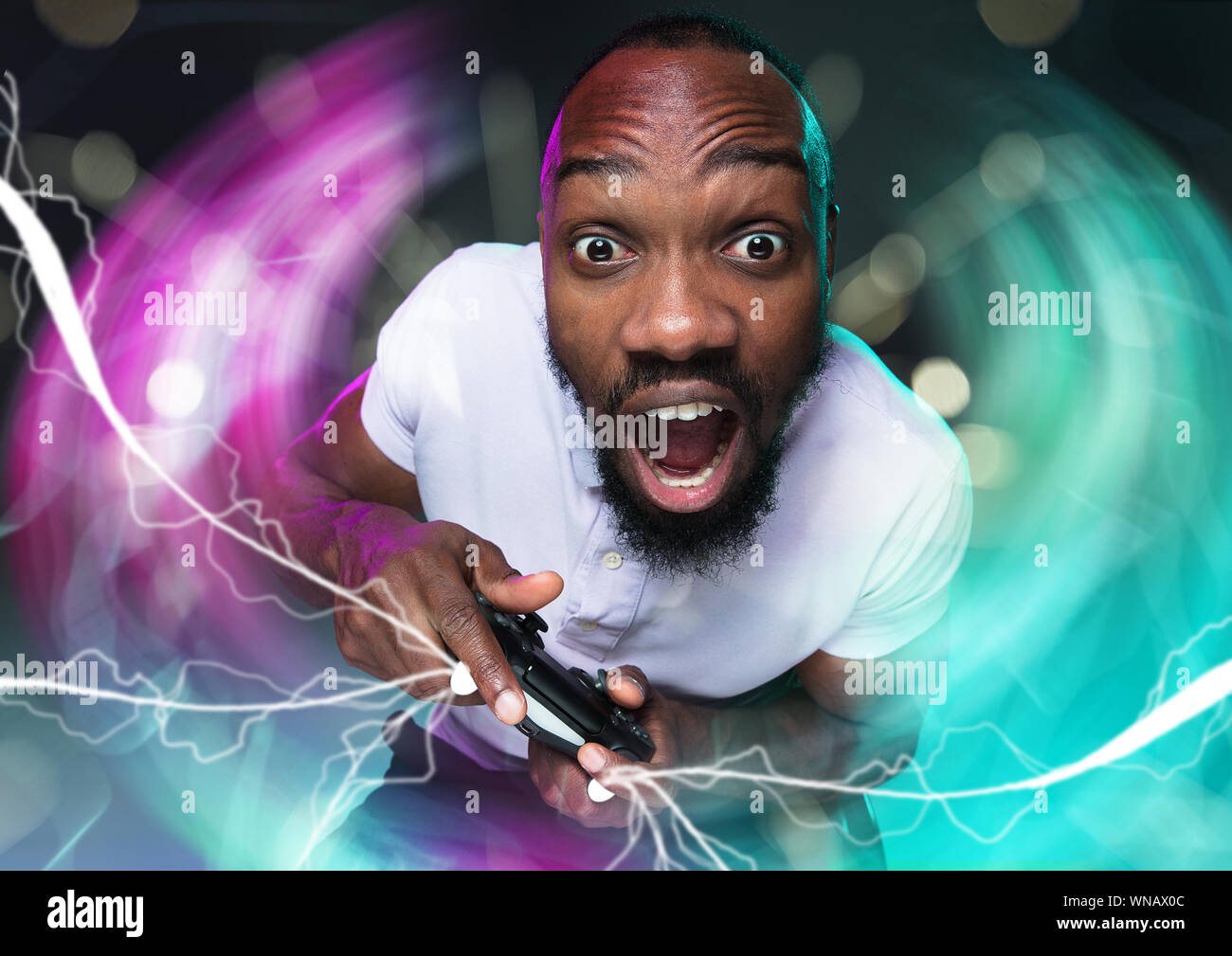 Passioned for winning. Young man holding a video game controller ...