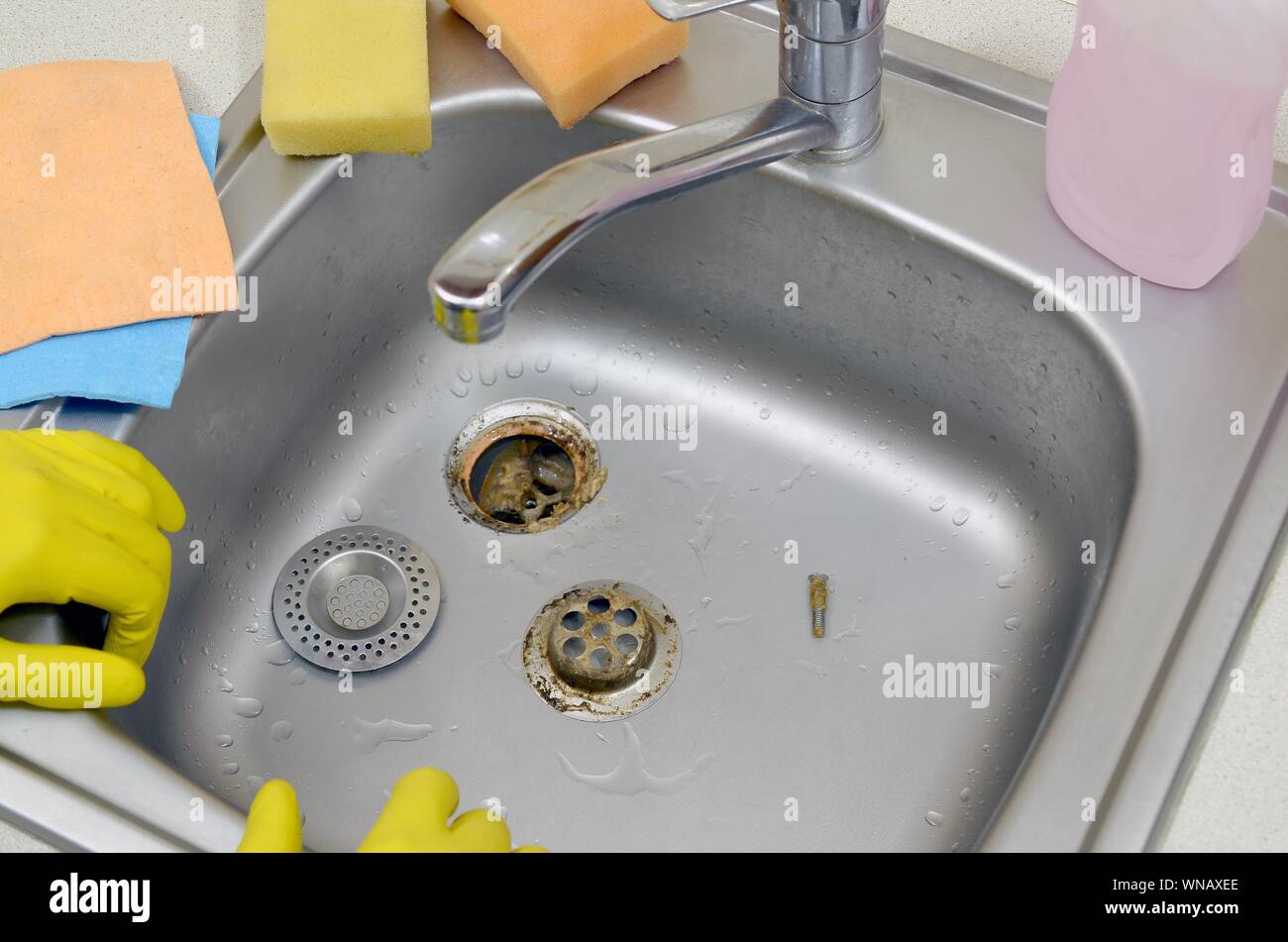 Silvery kitchen sink with a disassembled protective filter. Kitchen ...