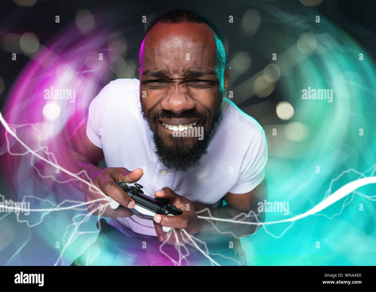 Passioned for winning. Young man holding a video game controller ...