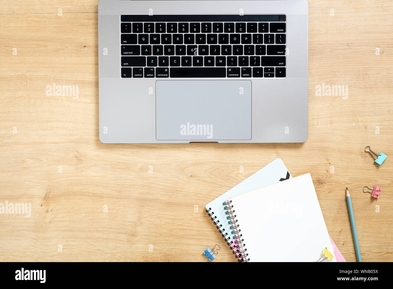 Wood office desk table with modern laptop computer, blank paper notepad ...