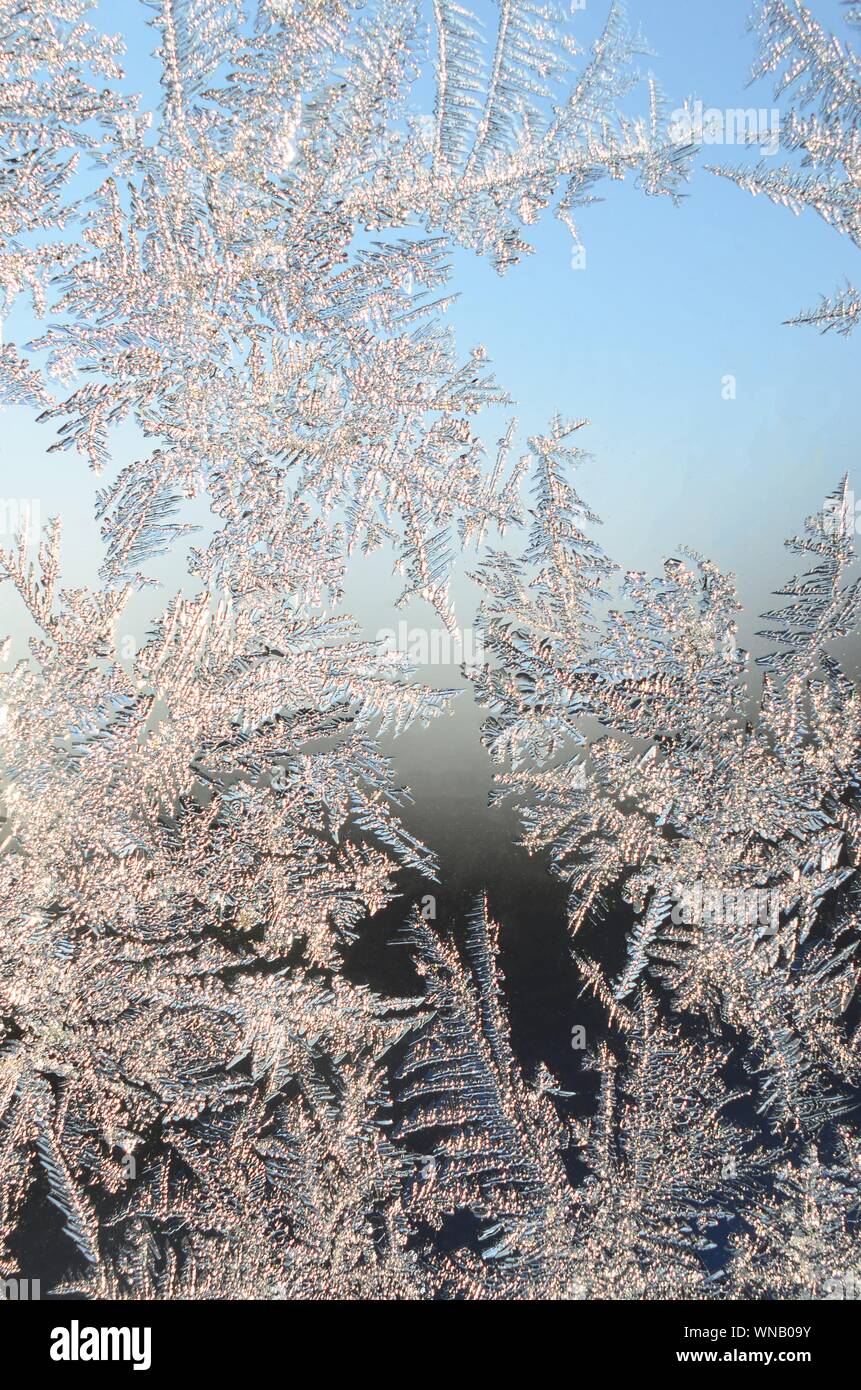Snowflakes frost rime macro on window glass pane. Colorful ice on the ...