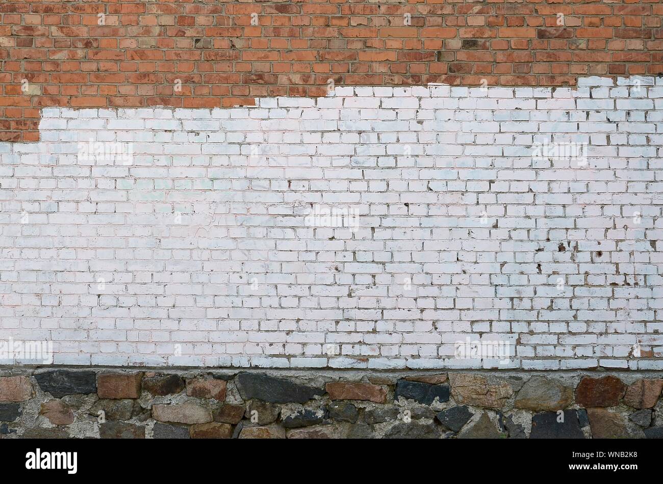 Residental house wall with white paint patches covering graffiti ...