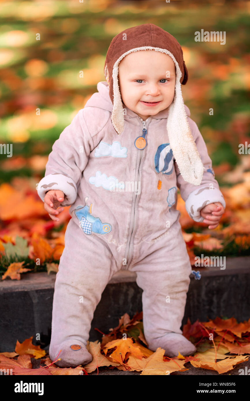 Cute little baby playing in autumn leaves. First autumn Stock Photo - Alamy