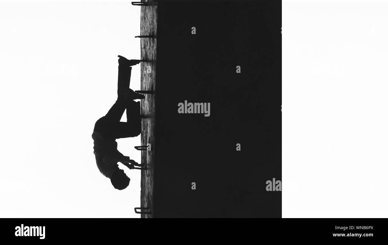 Man climbing up ladder hi-res stock photography and images - Alamy