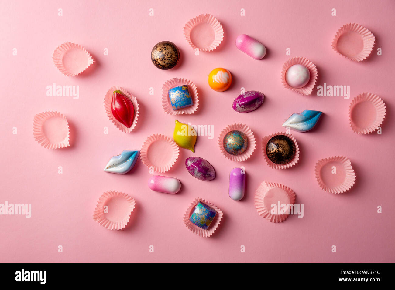 Pink food background with chocolate bonbons collection Stock Photo - Alamy