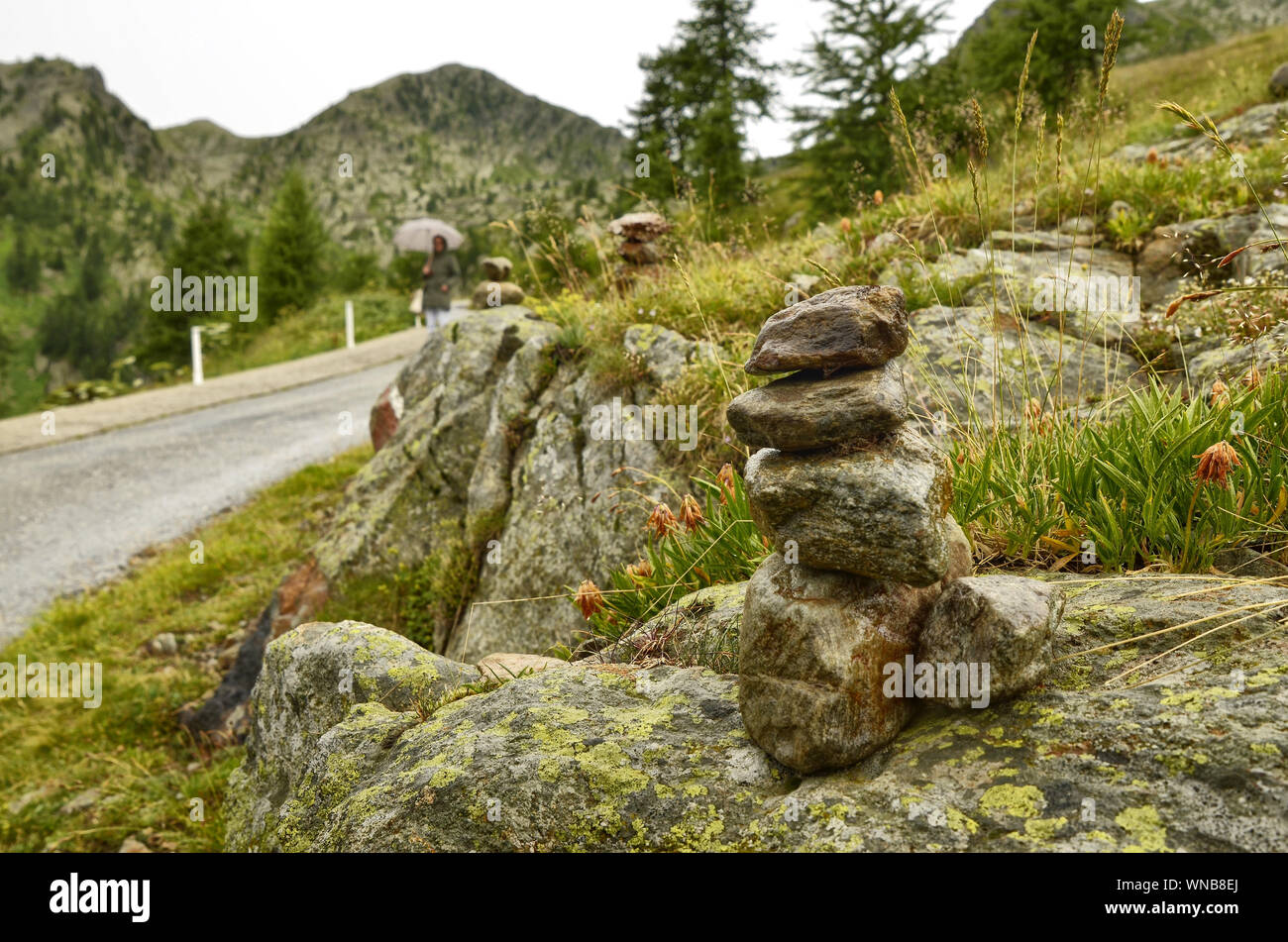 Stones piled up as a Zen memorial along a mountain road, in the ...