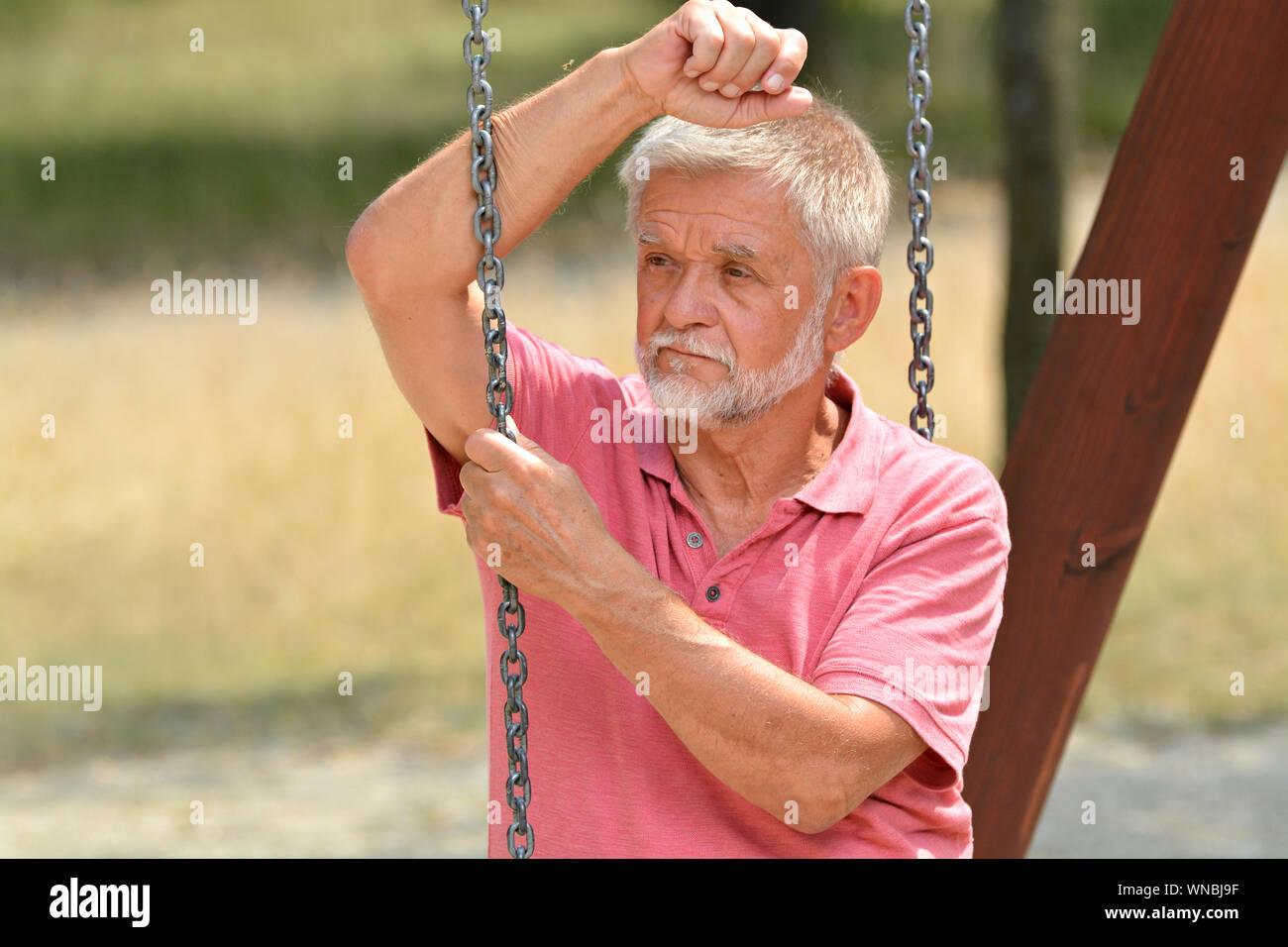 Old man on swing hi-res stock photography and images - Alamy