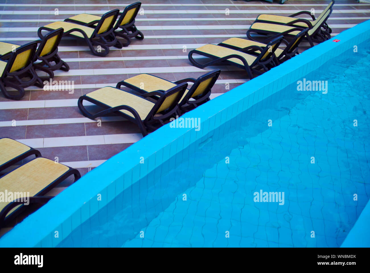 Deck chairs by swimming pool hi-res stock photography and images - Alamy