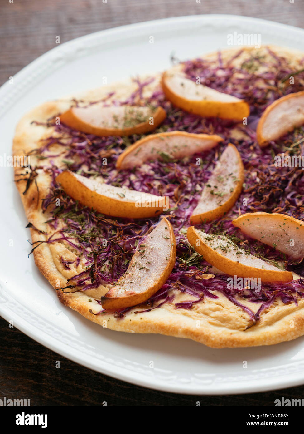 Traditional German flammkuchen (flatbread) with red cabbage and pears ...