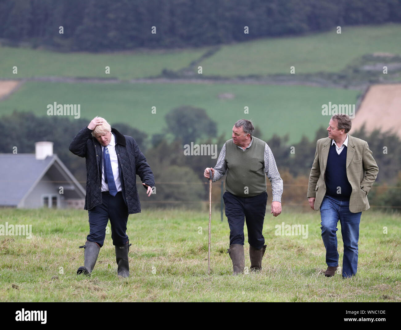 Prime Minister Boris Johnson with Farmer Peter Watson (centre) and ...