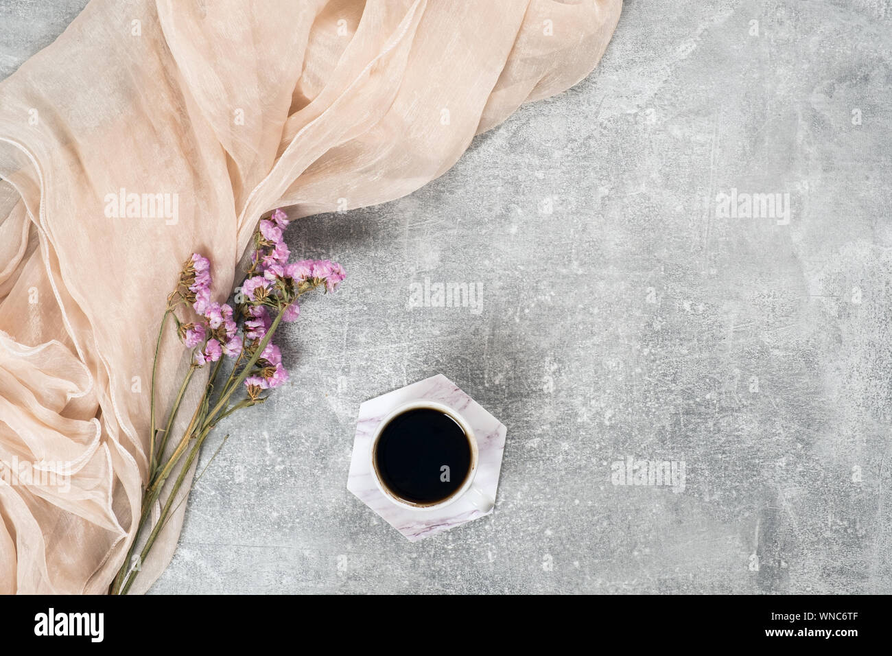 Minimal flat lay composition with scarf, coffee cup, pink dry flowers ...