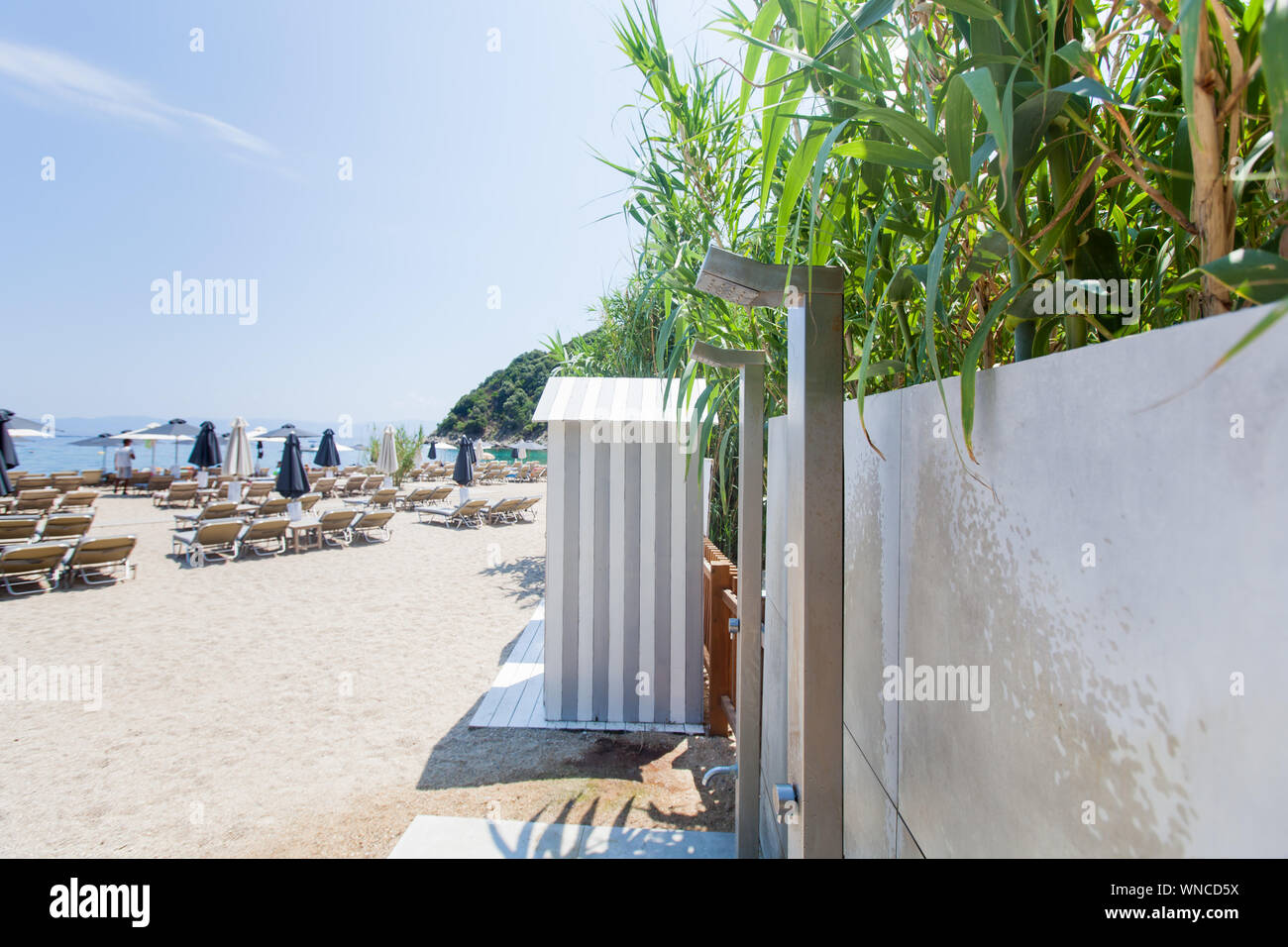 Shower and changing room on the sand beach on hot summer day. Travel ...