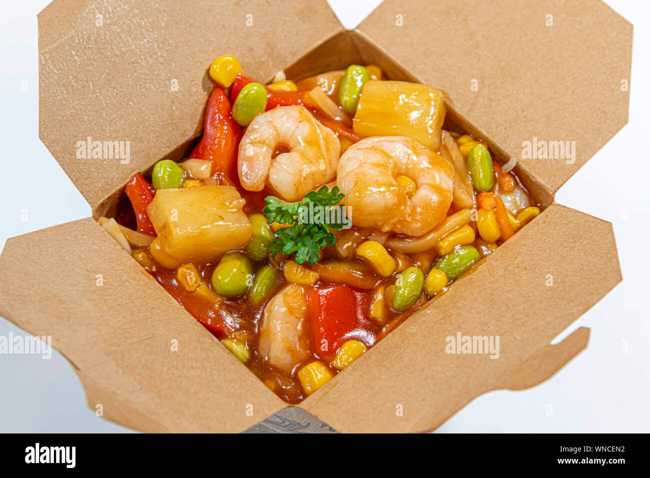 Box of stir fried chicken and shrimps noodle served in a paper box for ...