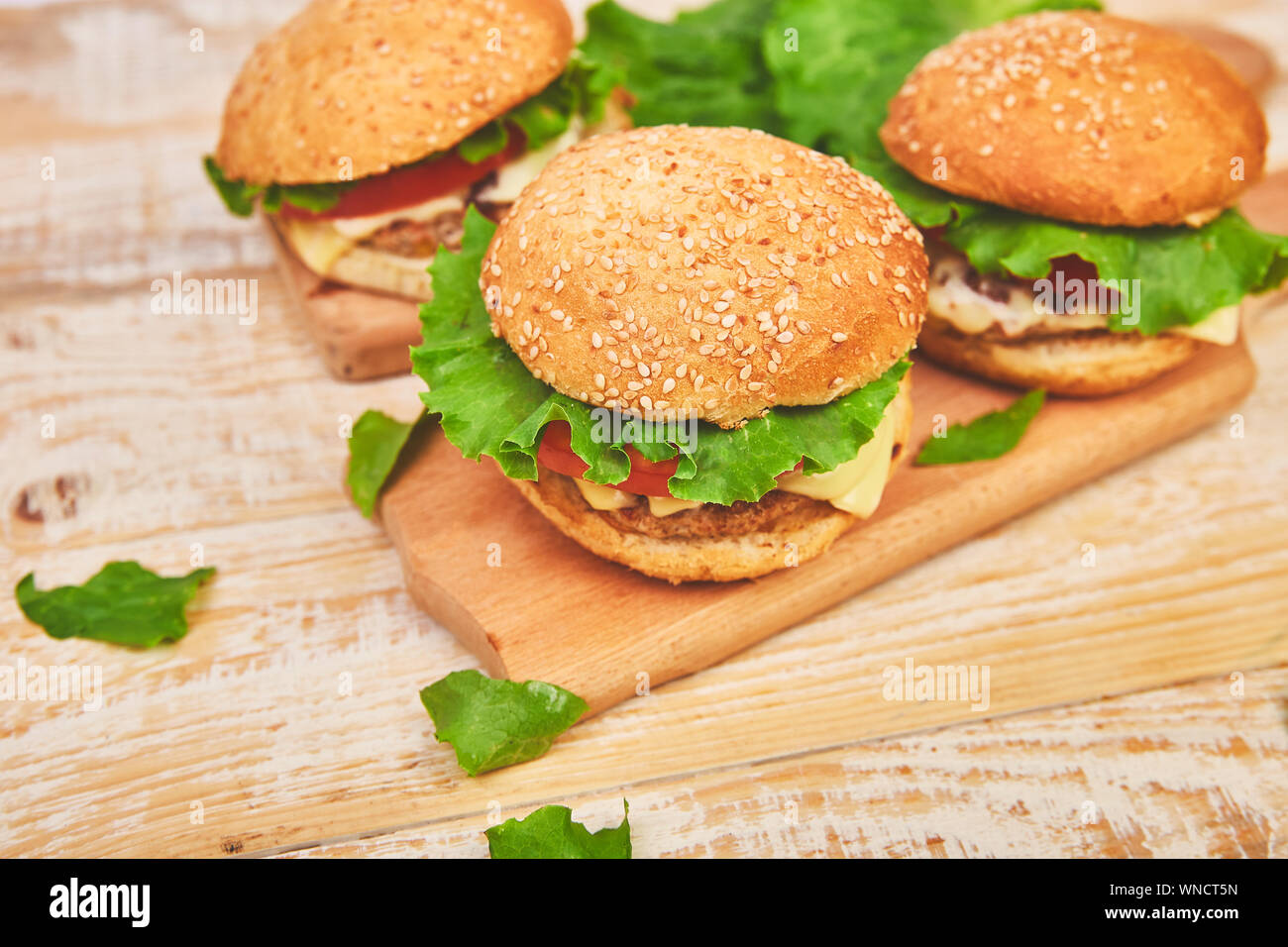 Craft beef burger on wooden table on light background Stock Photo - Alamy