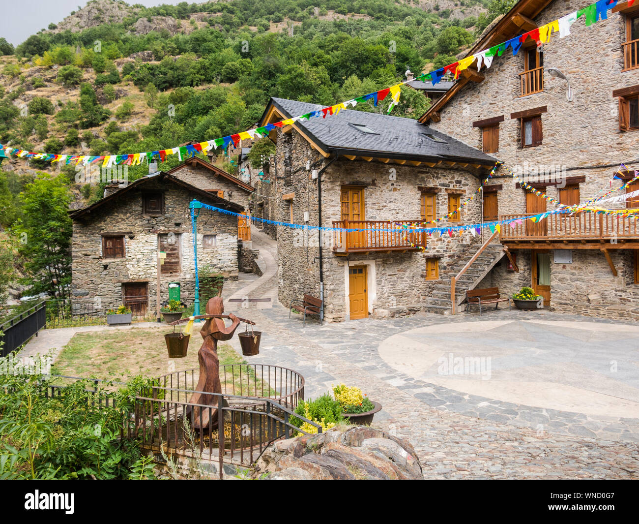 Square with a statue of a woman carrying buckets of water. Small ...