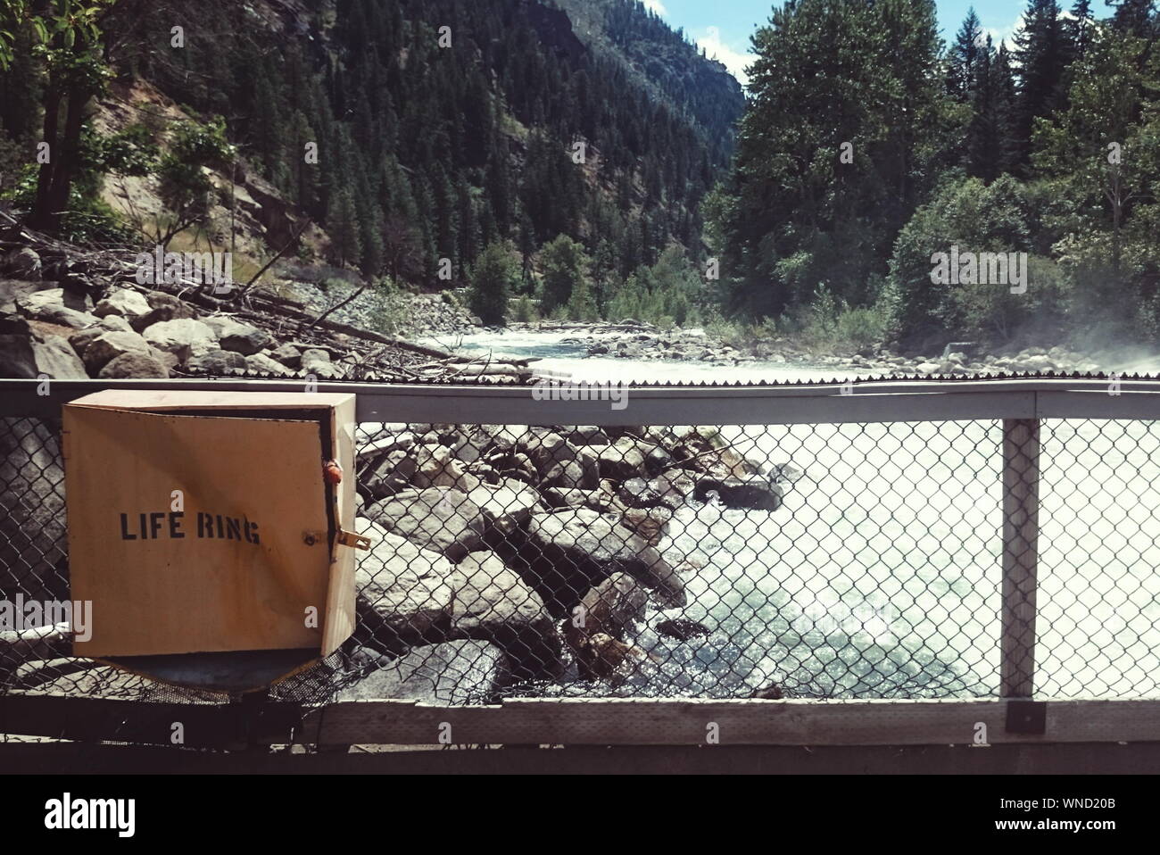 Lifeguard Belt Box On Railing By River Against Trees Stock Photo - Alamy