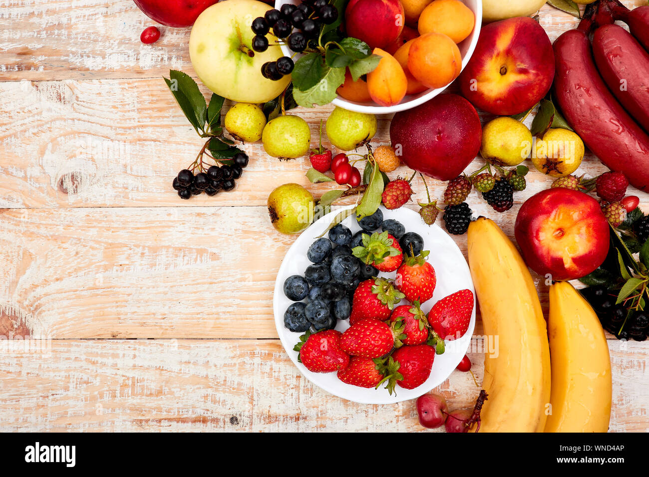 Flat lay of fruits over white wooden background Stock Photo - Alamy