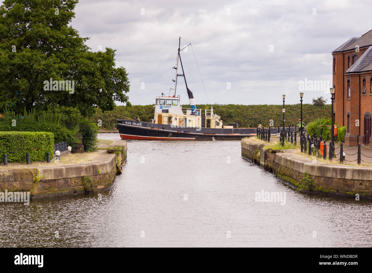 The tug boat M. S. C. Volant navigating the Manchester ship canal ...