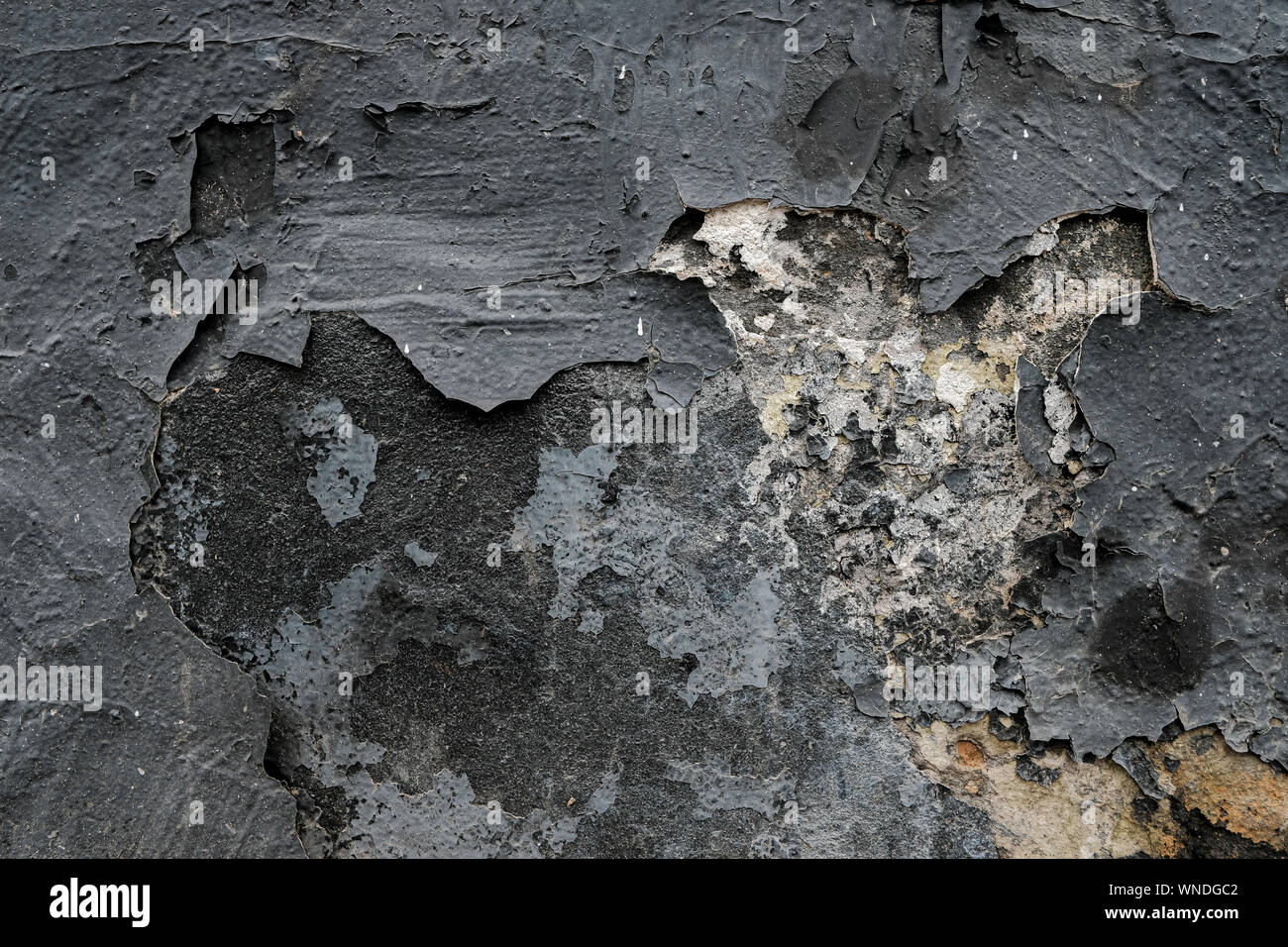 Old crumbling wall with peeling paint of black color Stock Photo - Alamy