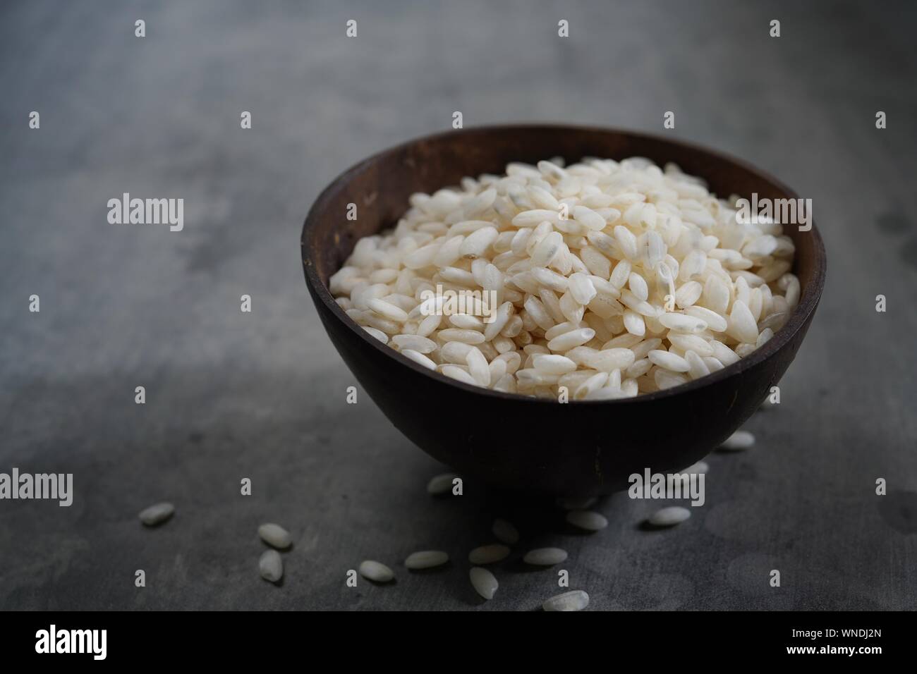 Raw Arborio rice in a bowl still life background Stock Photo - Alamy
