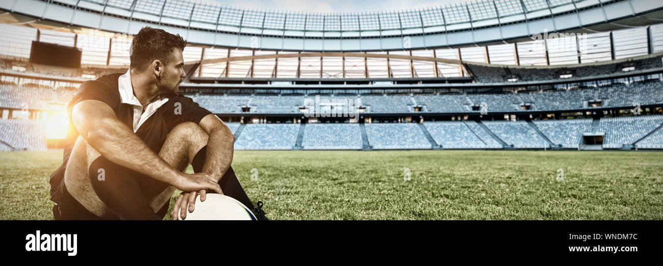 Composite image of rugby player sitting on the field with football ...