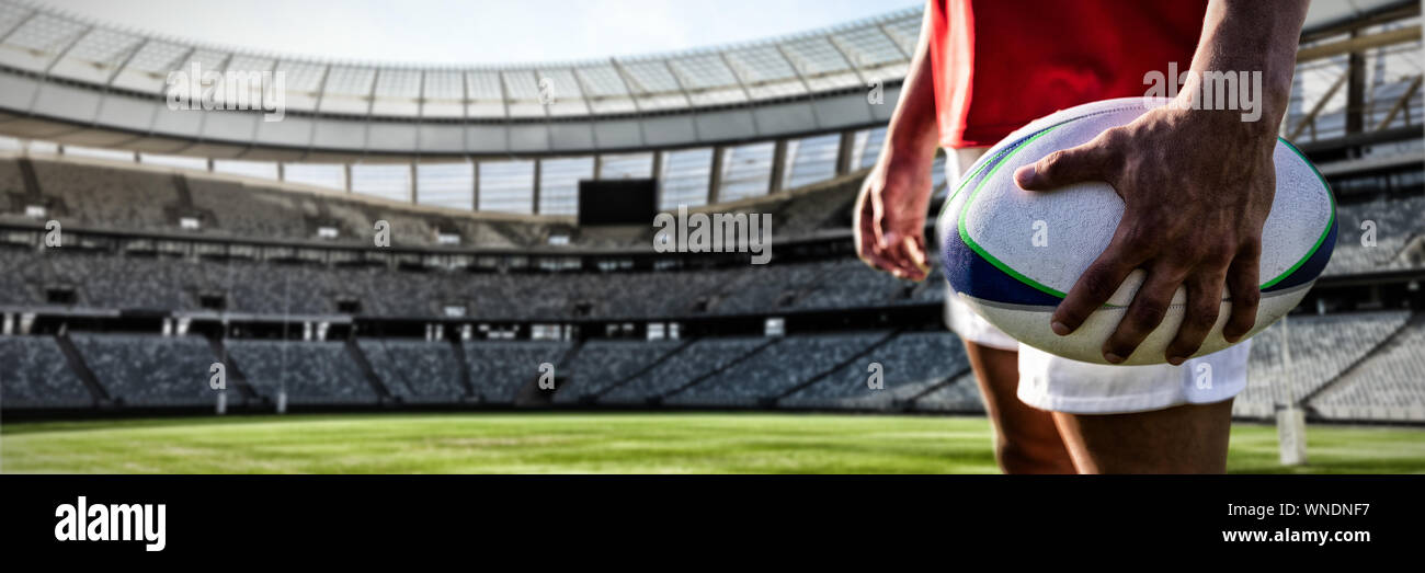 Composite image of rugby player holding rugby ball Stock Photo - Alamy