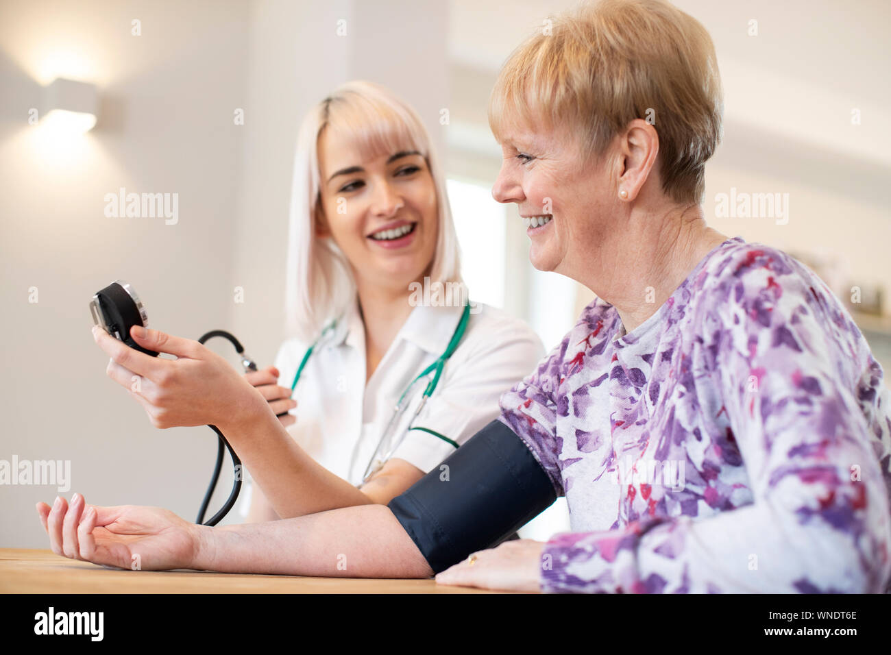 Nurse checking blood pressure hi-res stock photography and images - Alamy