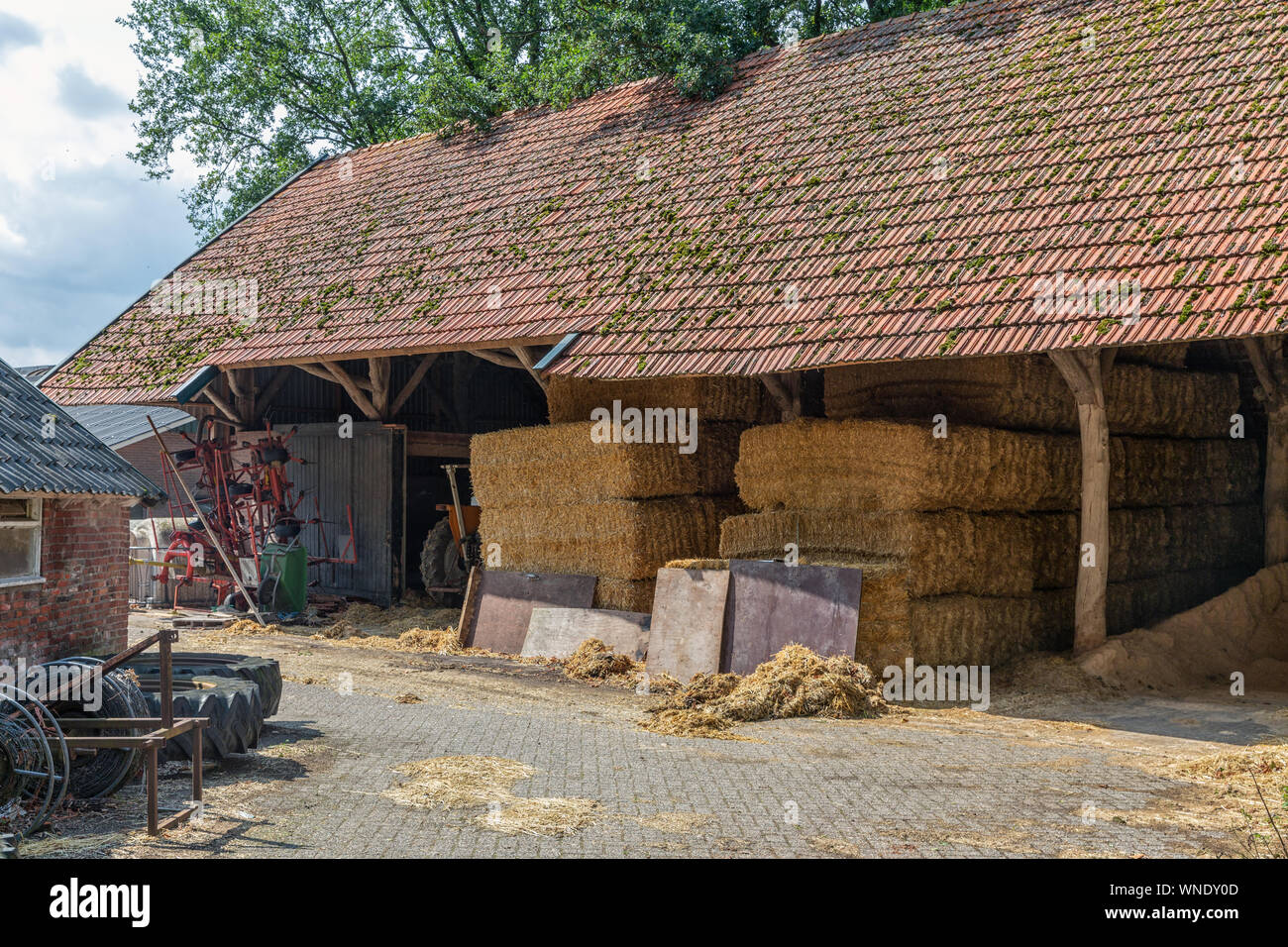 Dutch farmyard with stack of hay bales covered in shed Stock Photo - Alamy