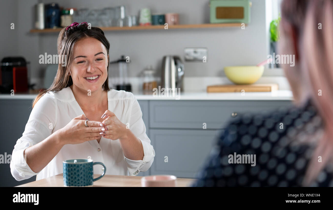 Two Women Having Conversation At Home Using Sign Language Stock Photo ...