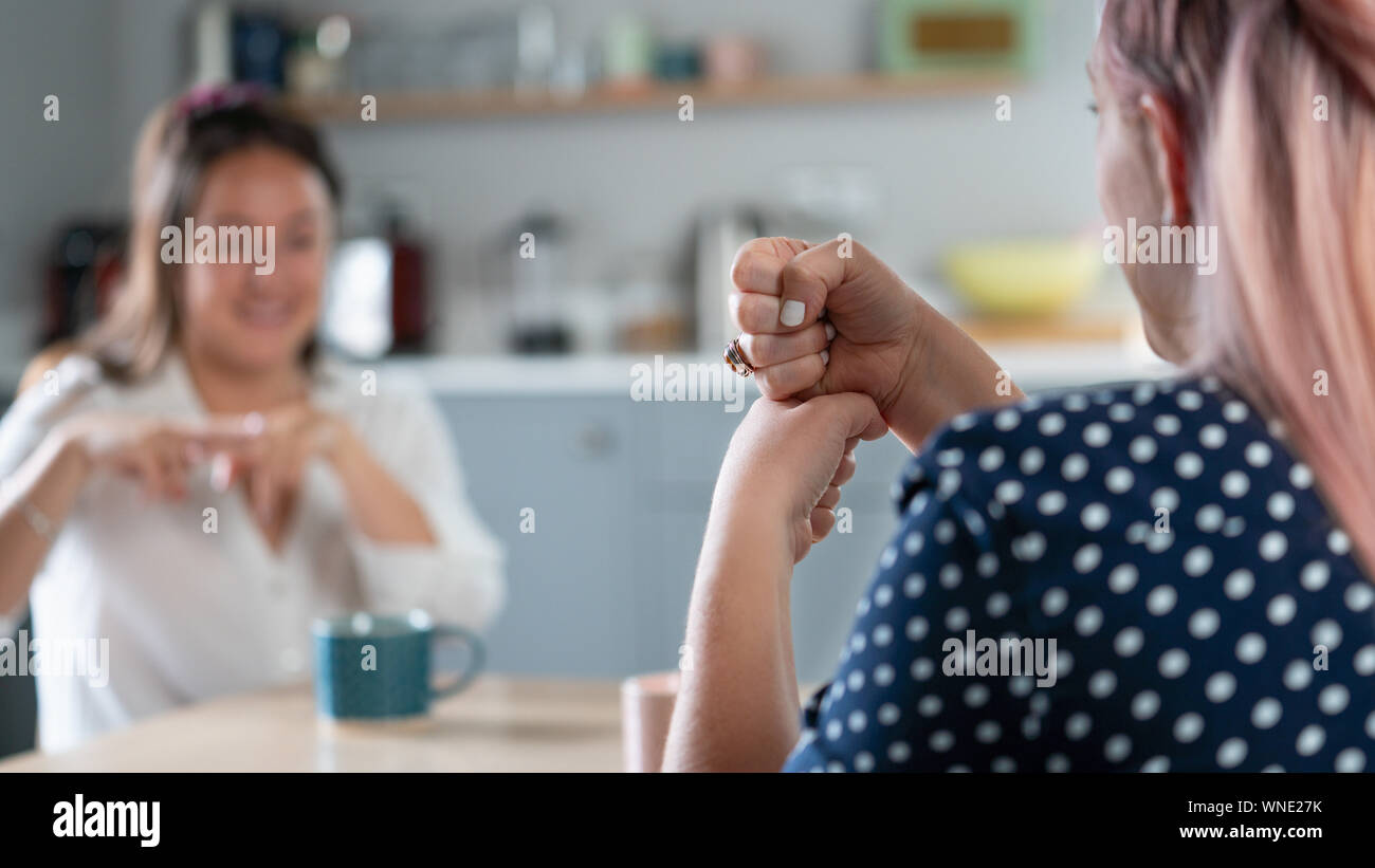 Two Women Having Conversation At Home Using Sign Language Stock Photo ...