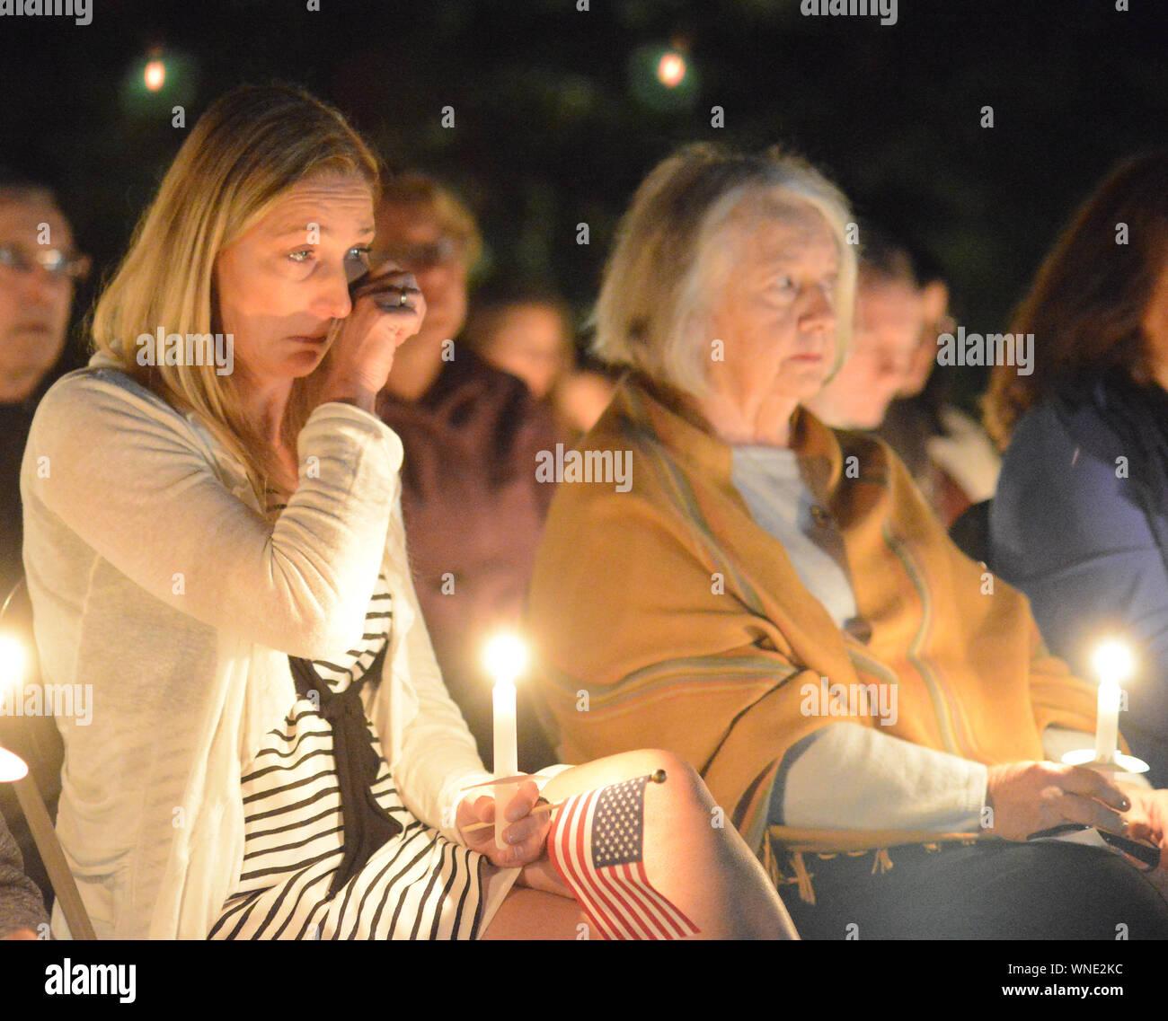 Tara Bane (left), who lost her husband Michael Bane, wipes a tear from ...