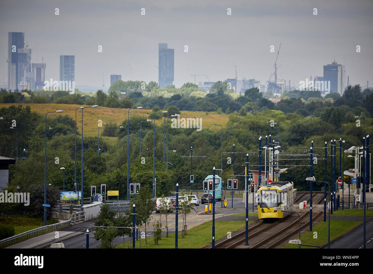 Metrolink tram in Ashton-under-Lyne passing the Ashton Moss Leisure ...