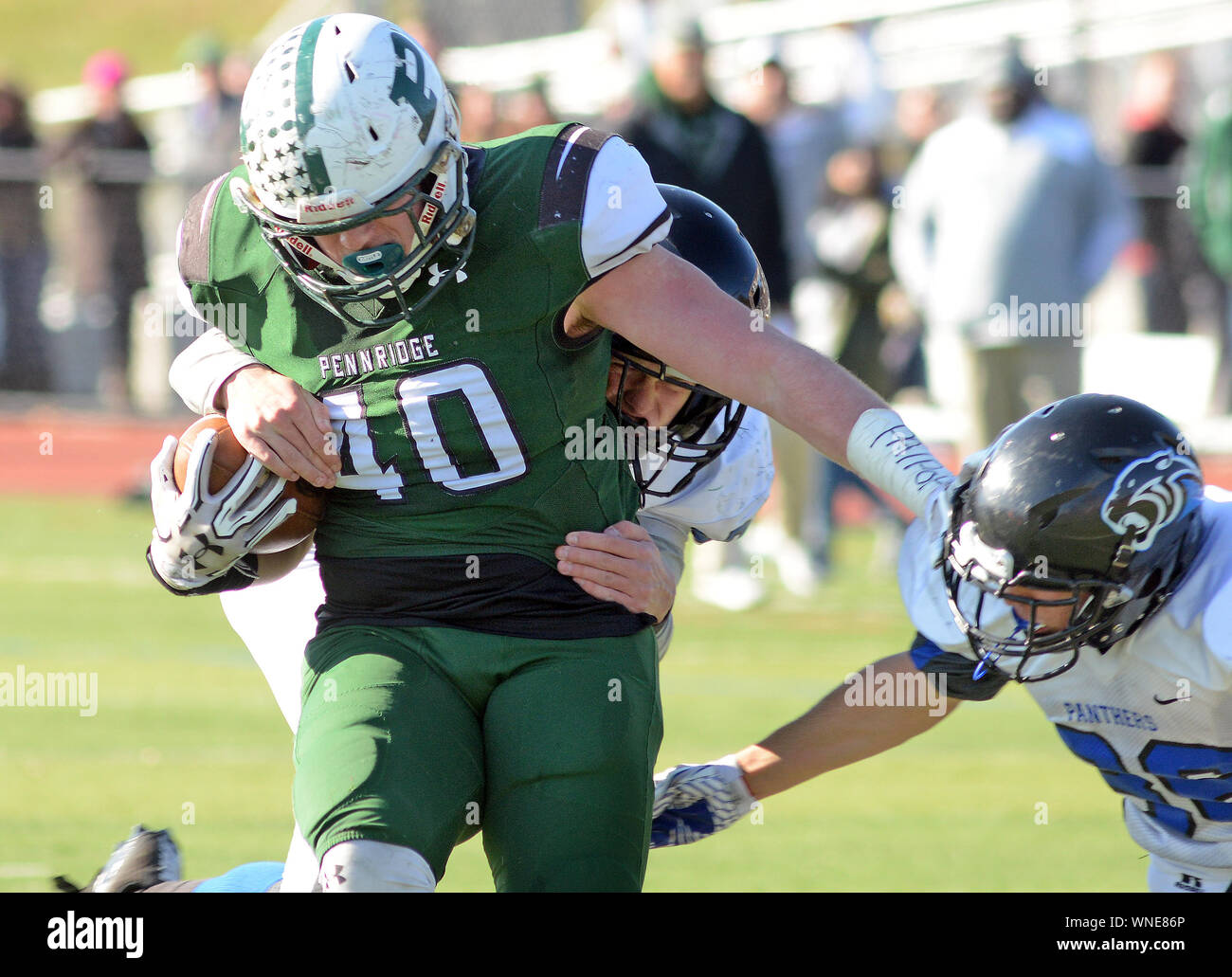 Pennridge's Nick Tarburton (40) runs with the ball as Quakertown's Matt ...